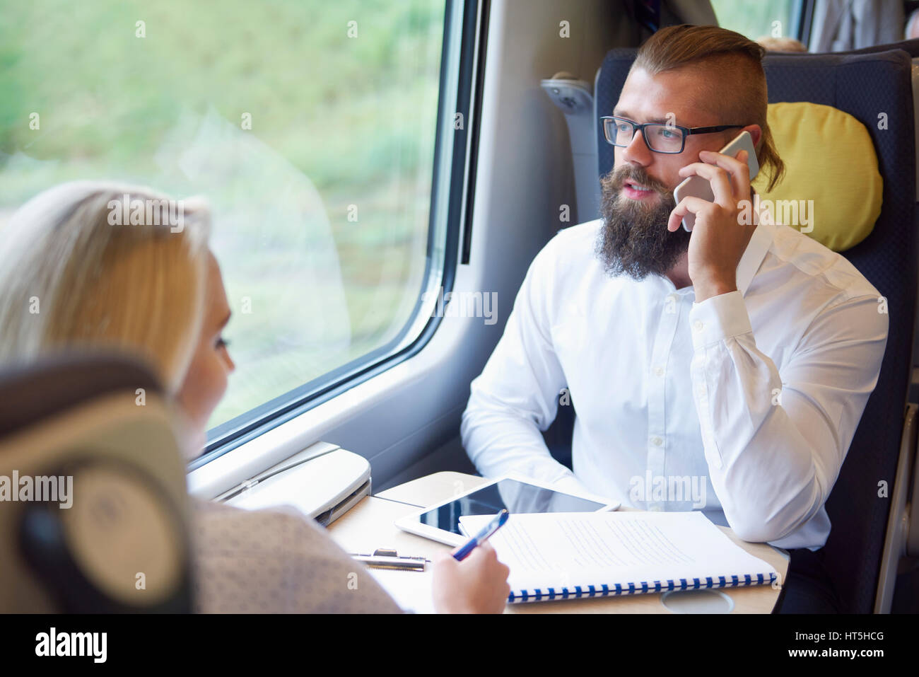 Busy business people on the train Stock Photo - Alamy