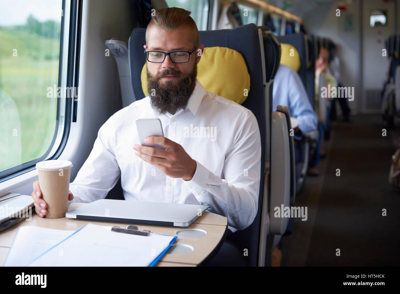 Businessman working on the train Stock Photo - Alamy