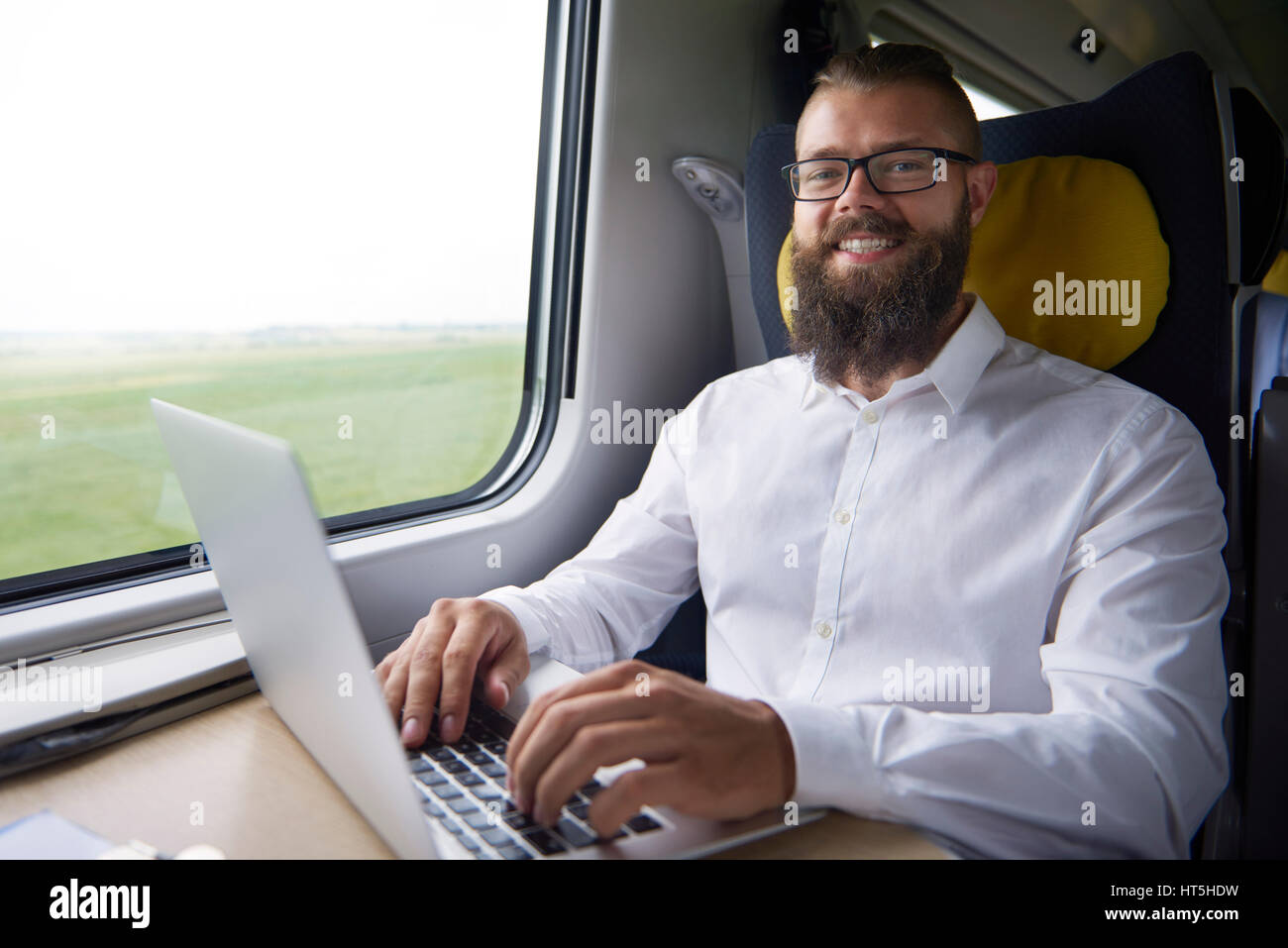 Portrait of young man working at the train Stock Photo - Alamy