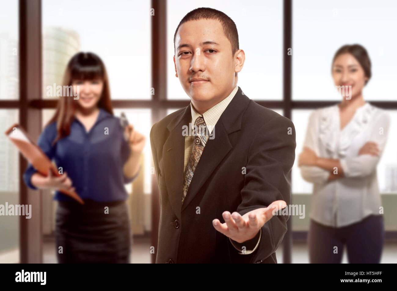 Young businessman standing with open hand ready to hand shake at office ...