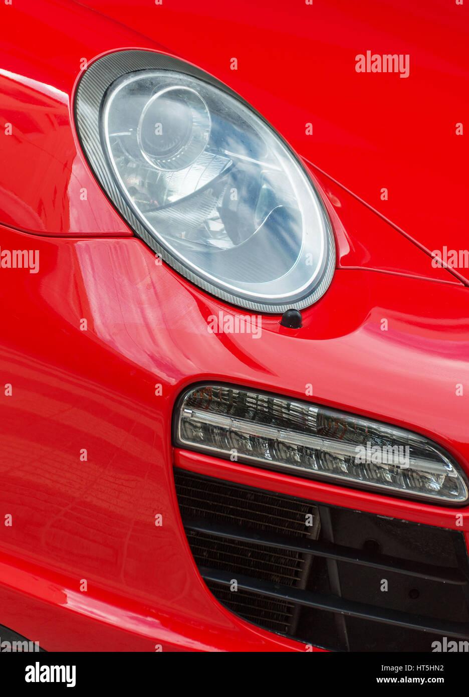 Close-up view of red sports car headlight Stock Photo - Alamy
