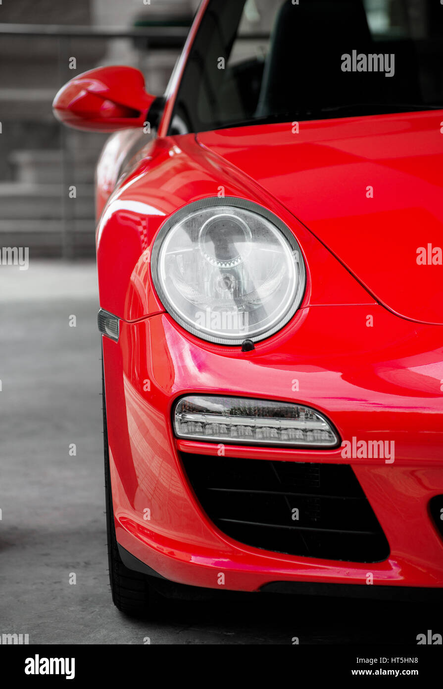 Close-up view of red sports car headlight Stock Photo - Alamy