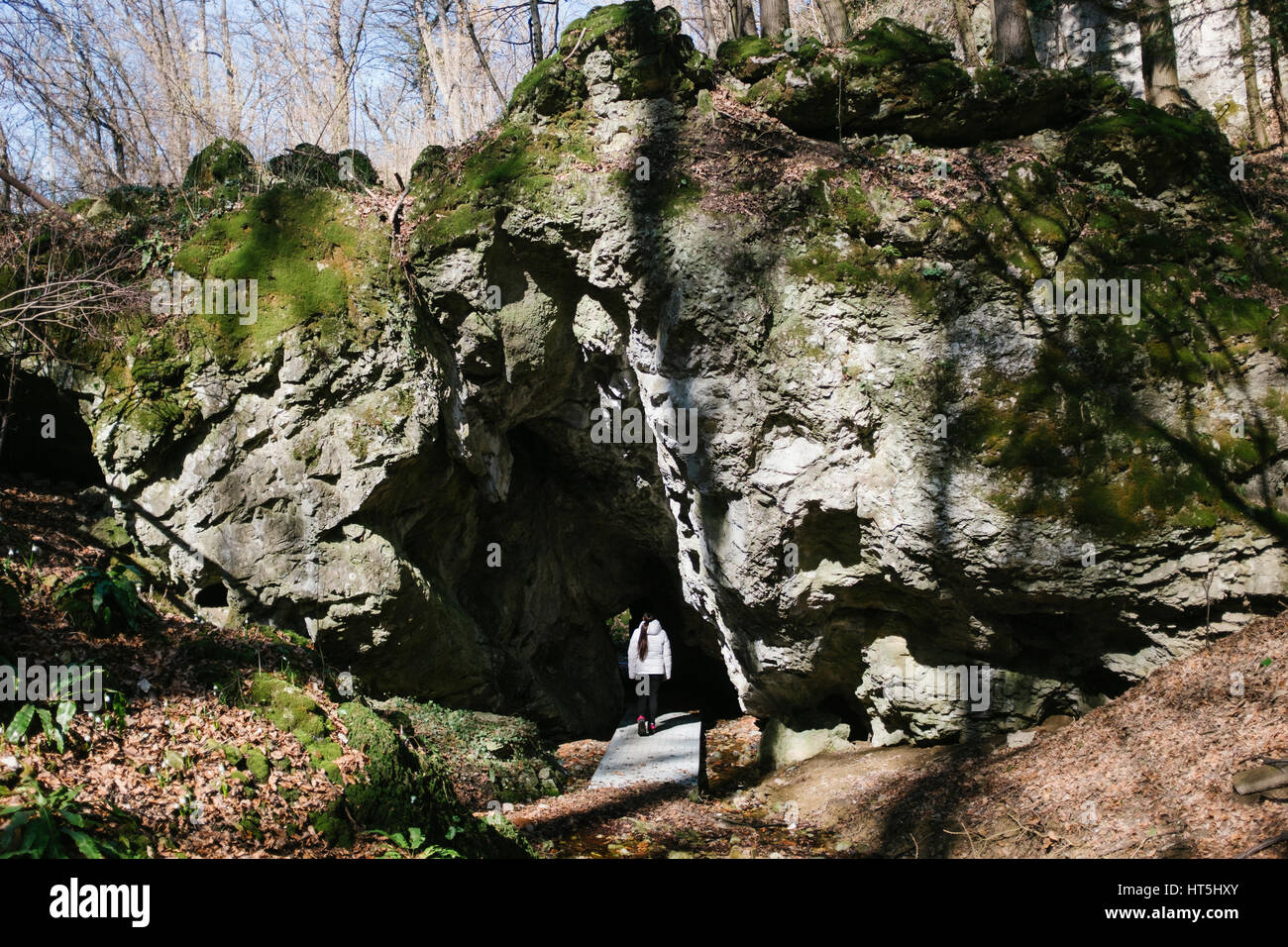 child passes under the pedestrian tunnel under large boulder Stock ...