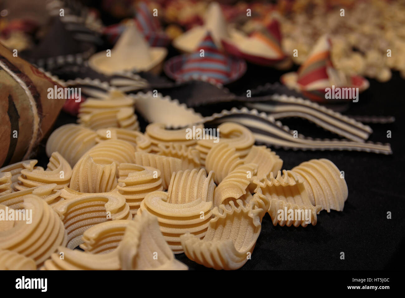 Uncooked Ruled and Curved Italian Pasta on Black Table Stock Photo - Alamy