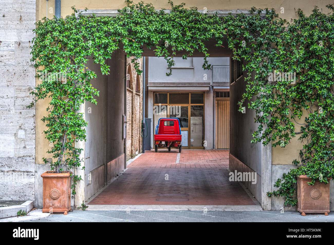 Three-wheeler car in a courtyard in Tuscany, Italy Stock Photo - Alamy