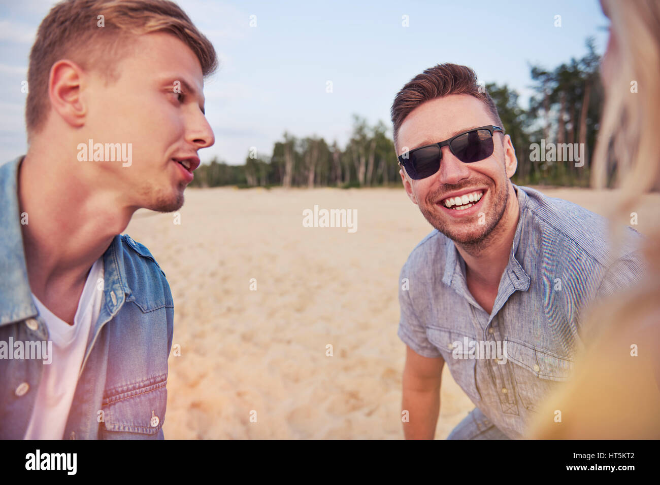 Men having fun on the beach Stock Photo - Alamy