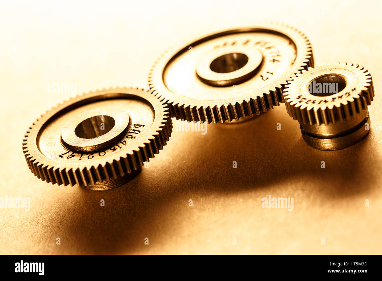 Three steel cogwheels in light closeup Stock Photo - Alamy