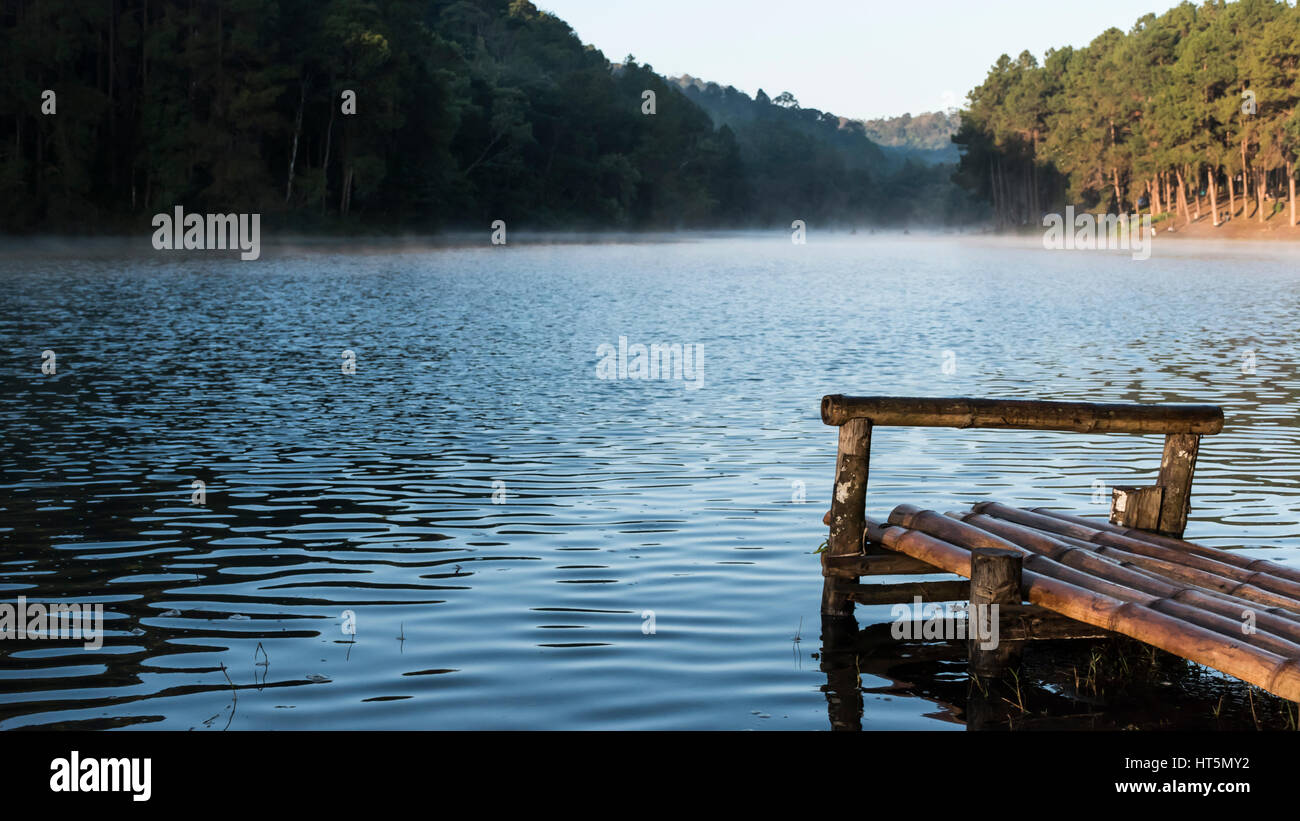 The wooden port at the reservoir with mist in the morning Stock Photo ...