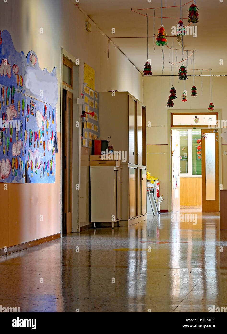 inside of a long corridor of the kindergarten with children's drawings ...