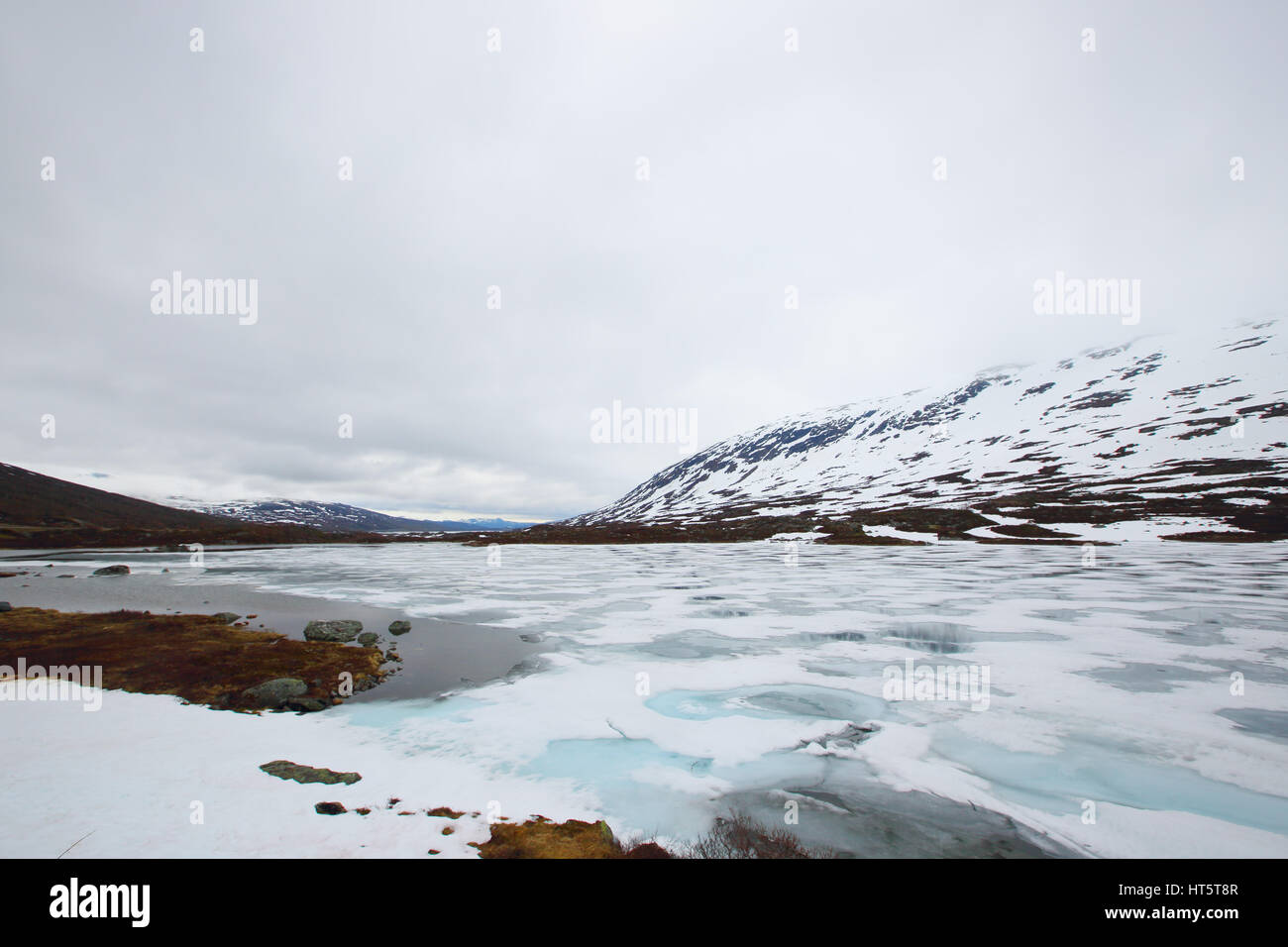 View of beautiful spring Norway landscape with mountains and melting ...