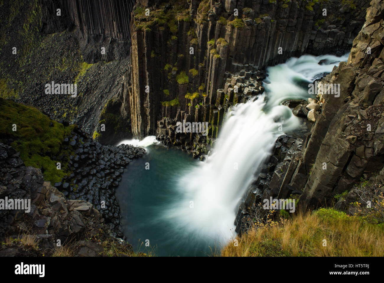Litlanesfoss waterfall and river flowing between basalt columns ...