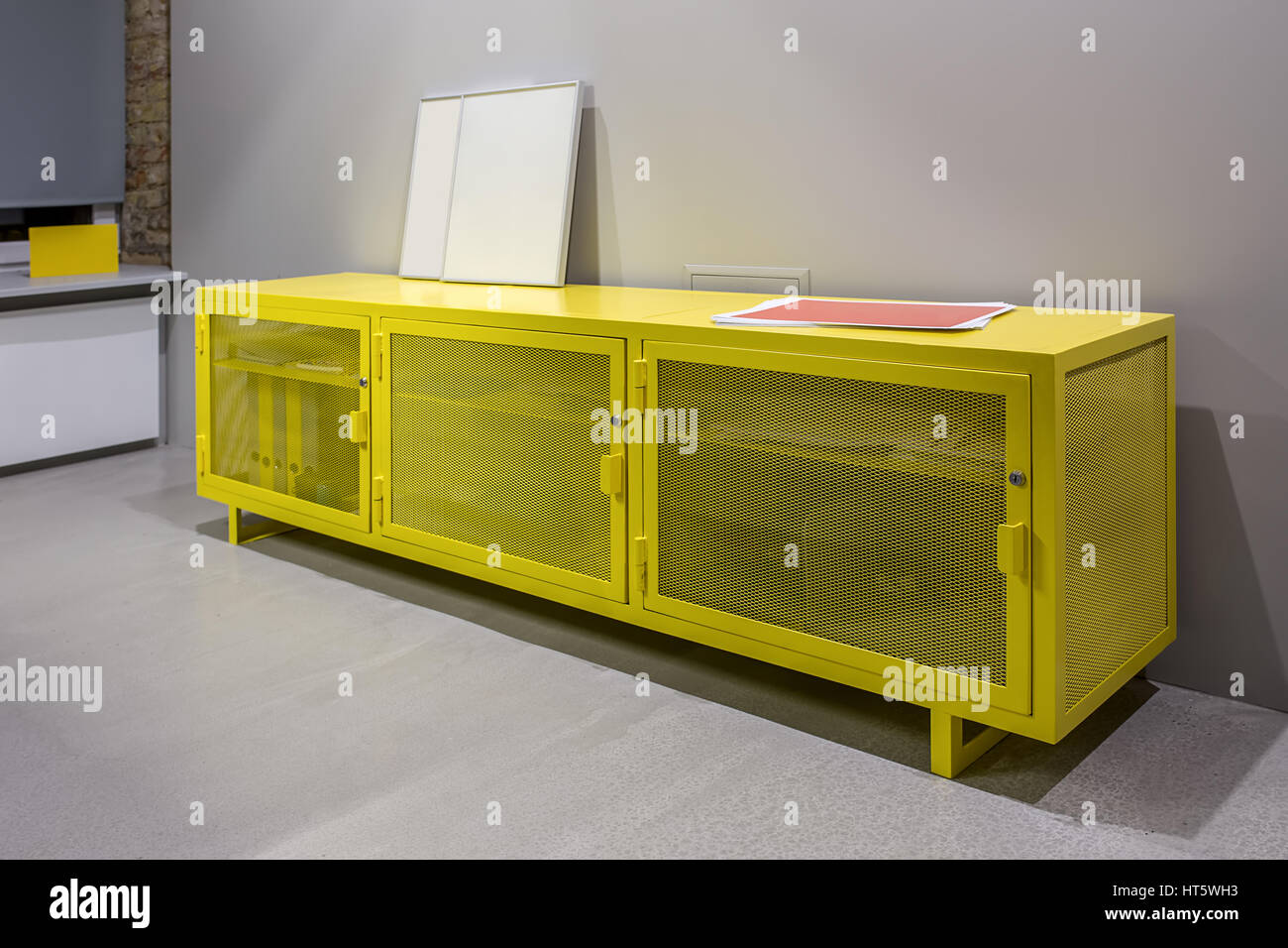 Reticulated metal yellow lockers on the background of the gray wall in ...