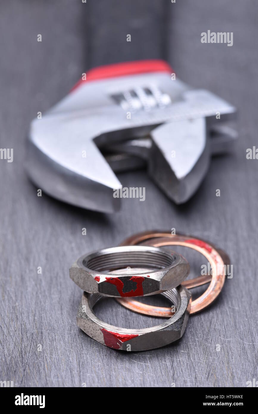 Close up fixing elements nuts, washers and working tool wrench Stock ...