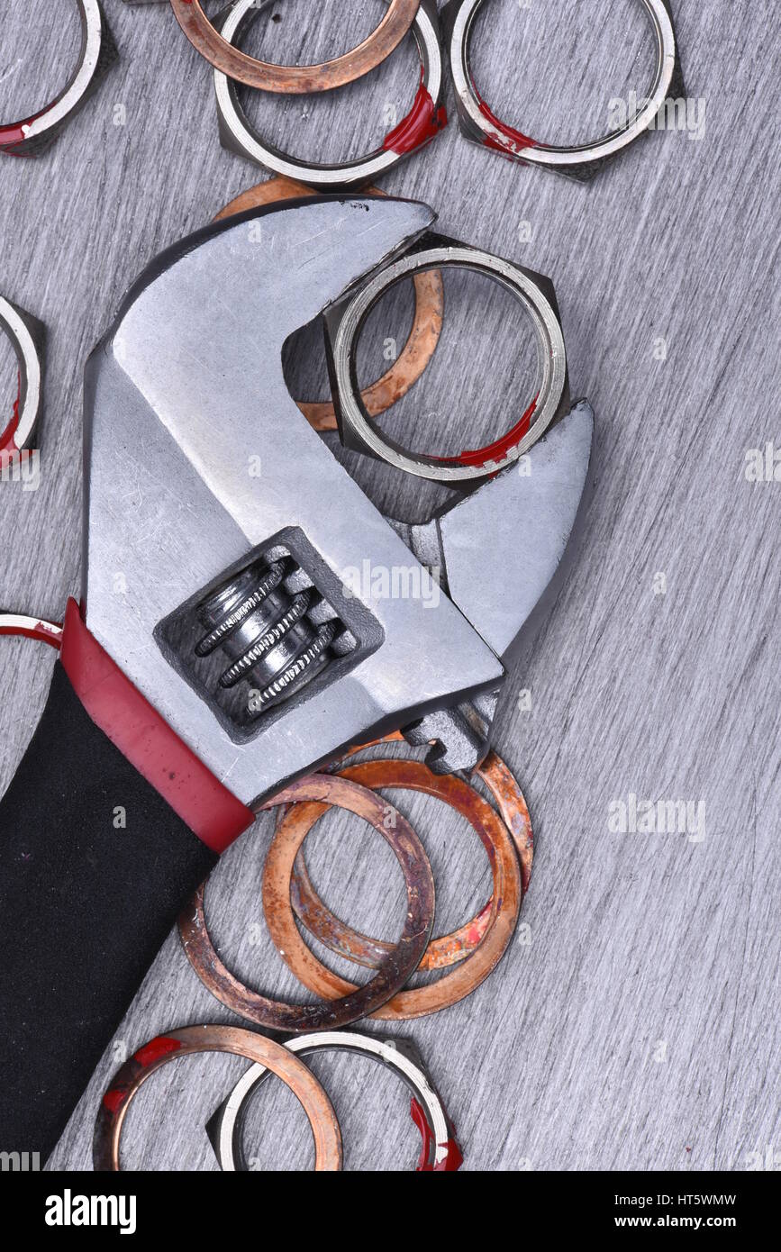 Close up fixing elements nuts, washers and working tool wrench Stock ...