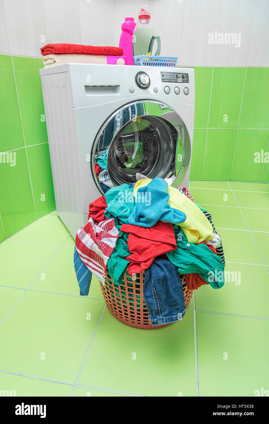 Washing machine and laundry basket. Preparing the wash cycle Stock ...