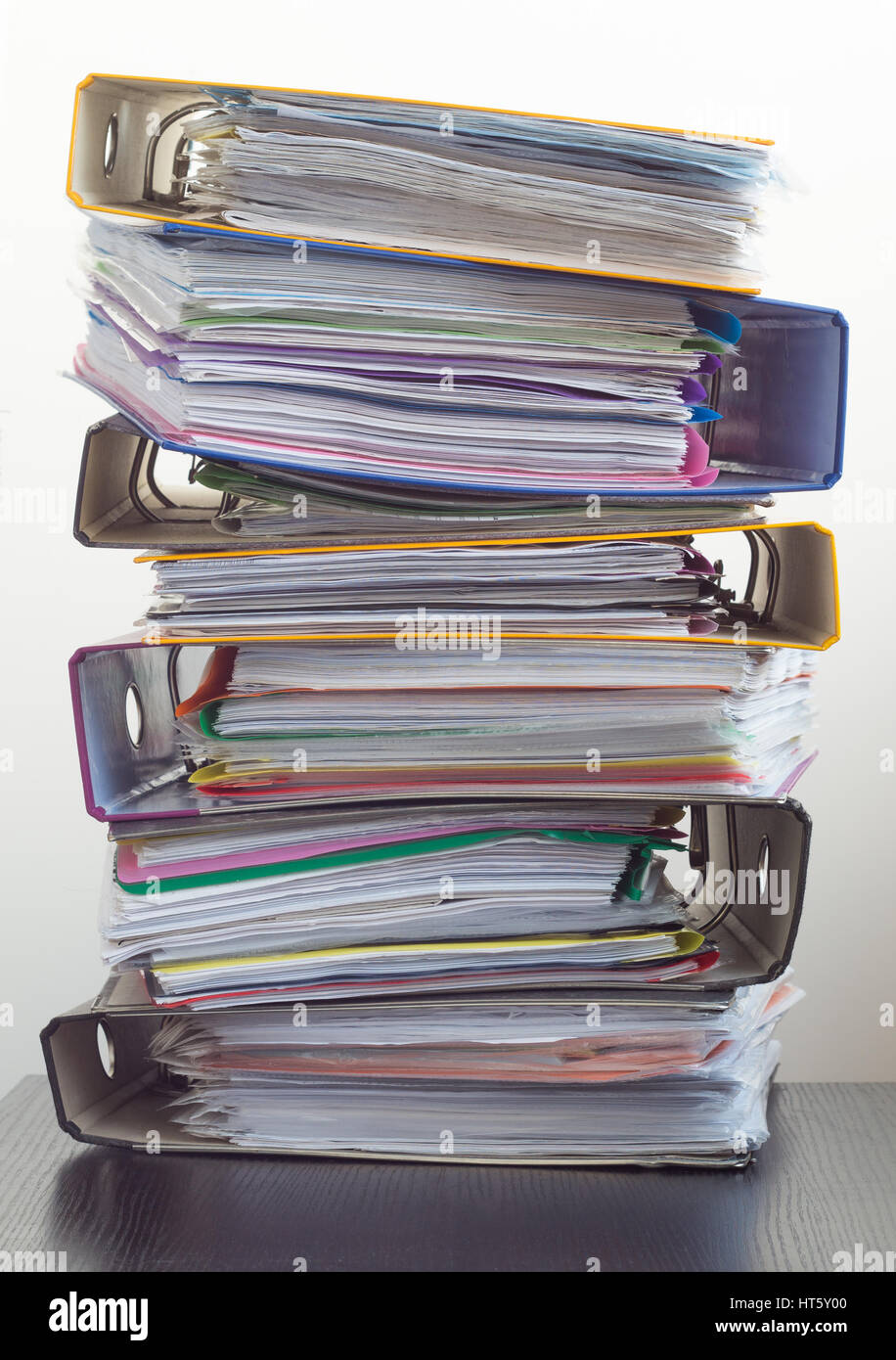 Seven folders with documents stacked in a pile on the table Stock Photo ...