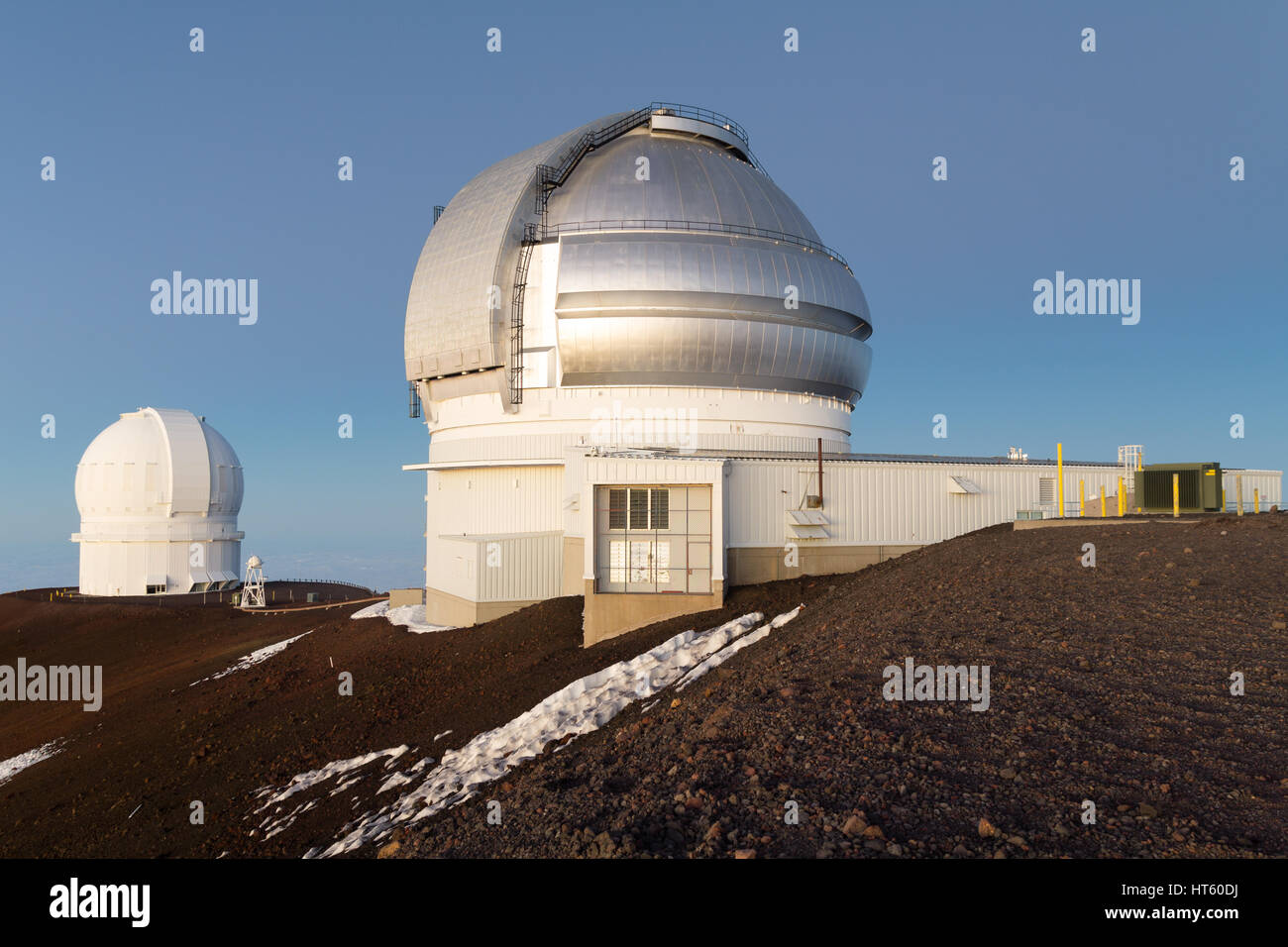 The Canada-France-Hawaii and Gemini Observatories against blue sky at ...