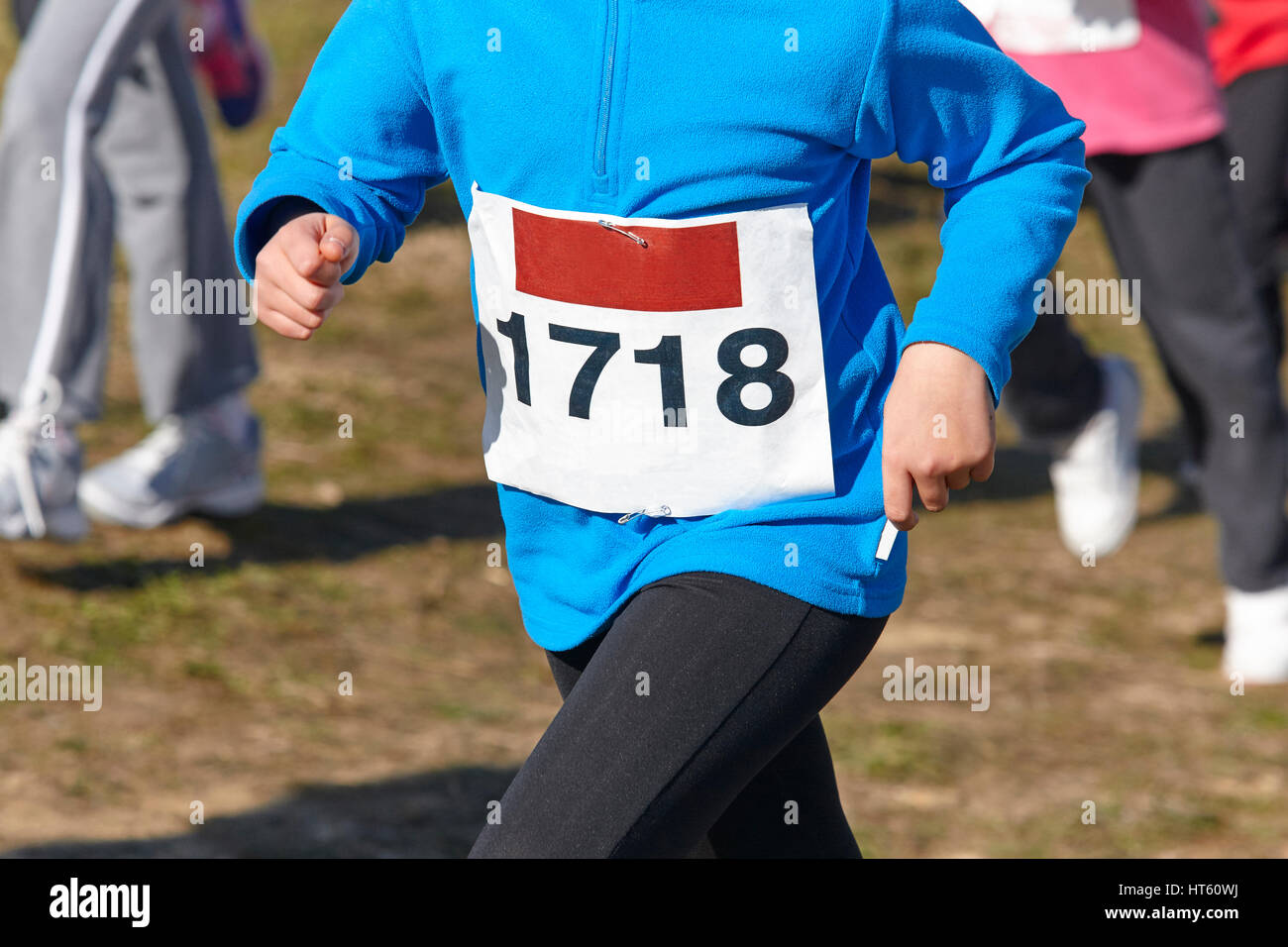 Young athletic runners on a race. Outdoor circuit. Horizontal Stock ...