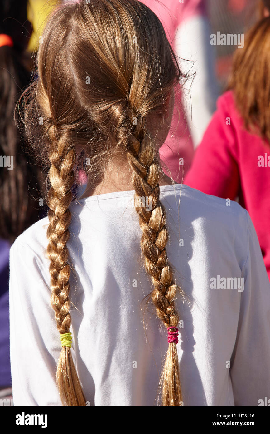 Young girl with braids on her back. Outdoors. Vertical format Stock ...