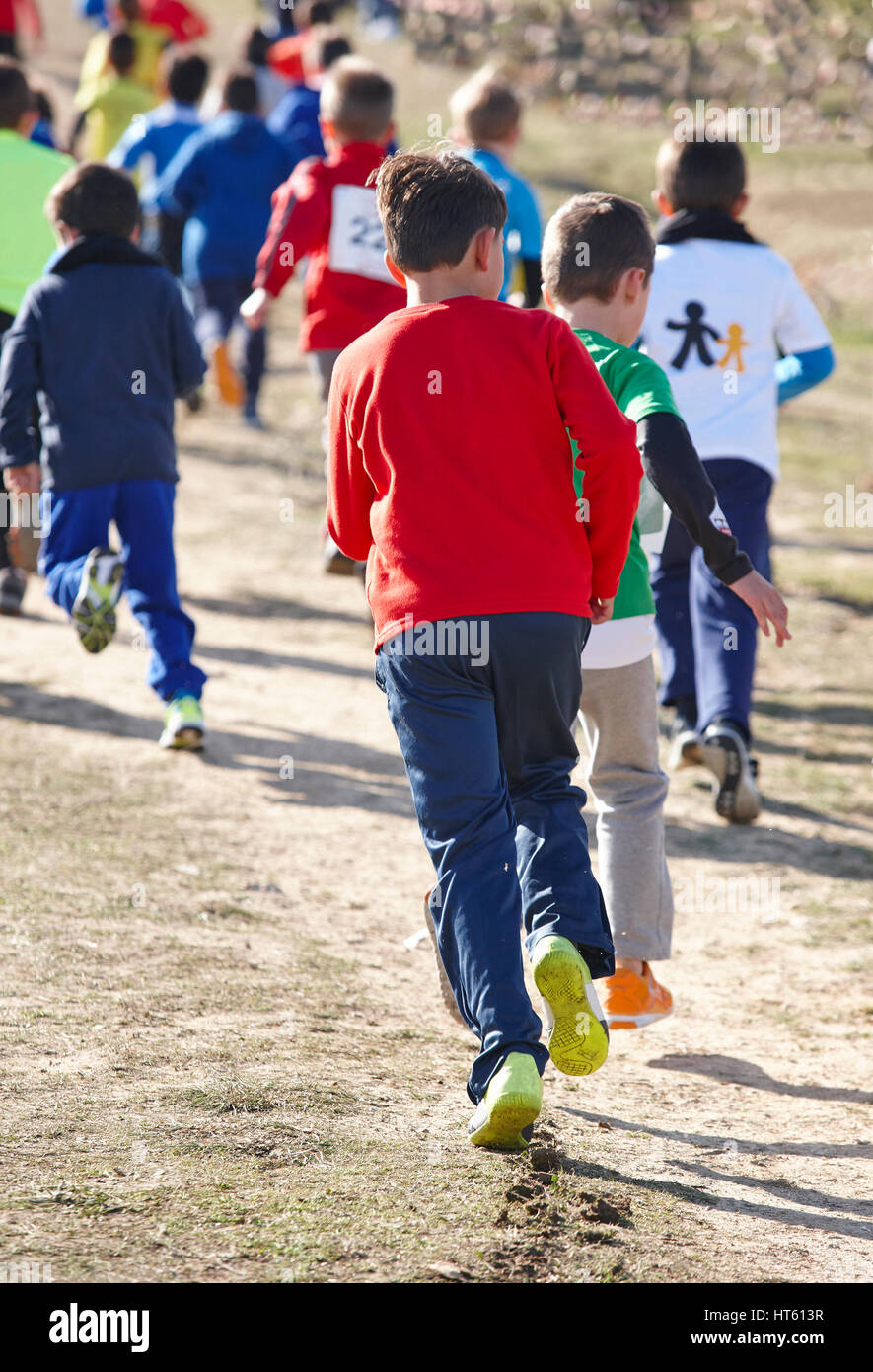 Junior athletics runner on a cross country race. Outdoor circuit ...