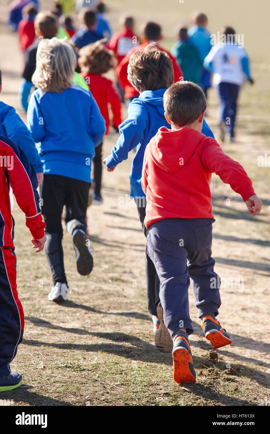 Children athletics runner on a cross country race. Outdoor circuit ...
