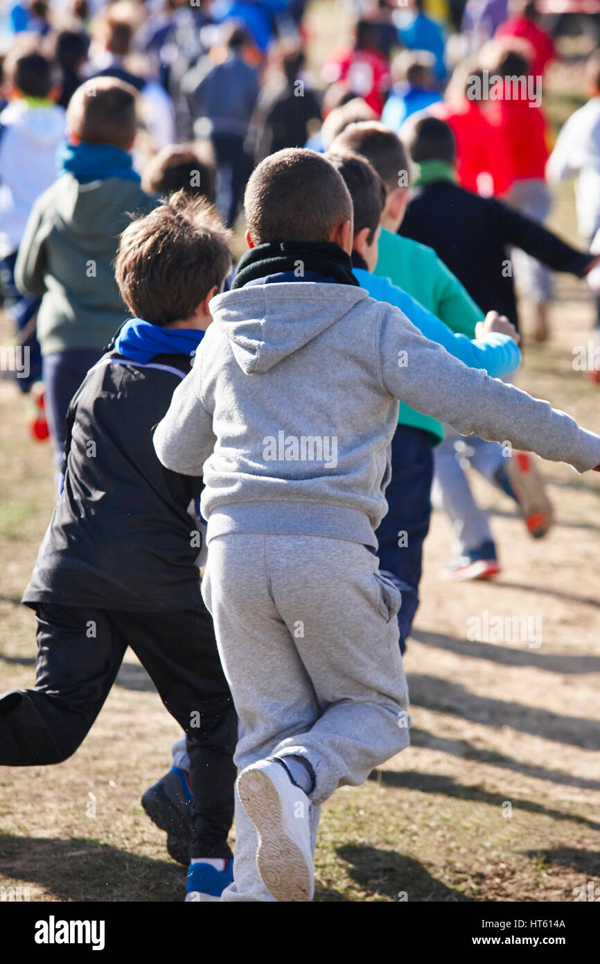 Children athletics runner on a cross country race. Outdoor circuit ...