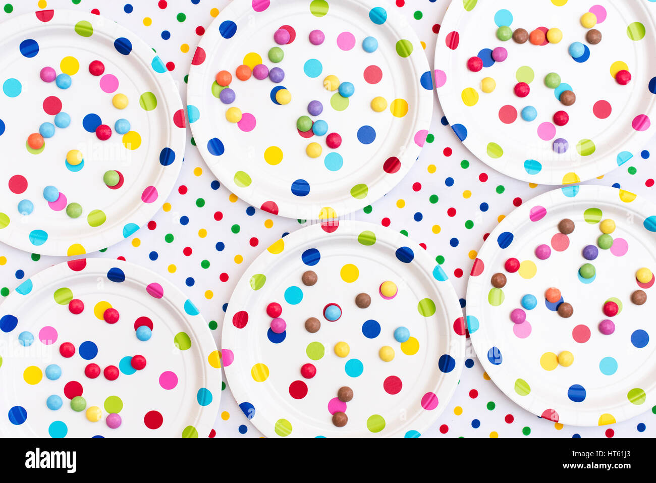 Smarties on colourful polka dot paper plates on a polka dot table cloth ...