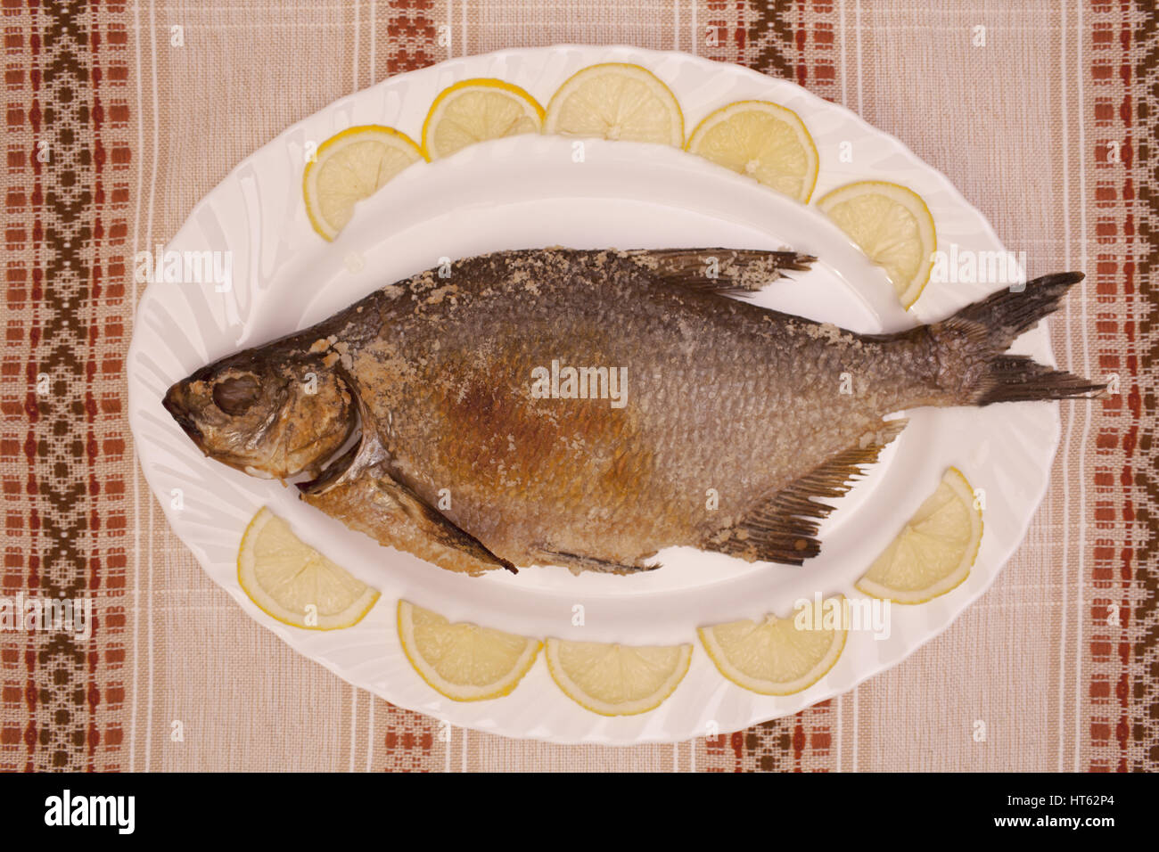 Fish bream baked in oven with lemon Stock Photo - Alamy