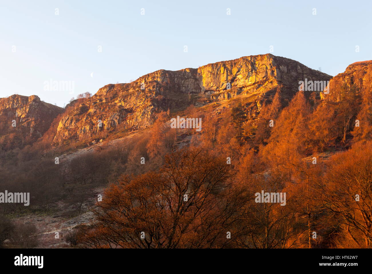 A quarter moon sets over the cliff tops near Pistyll Rhaeadr Stock ...