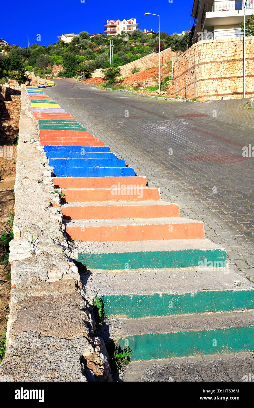 Multicolor painted steps of a concrete staircase on the sidewalk of a ...