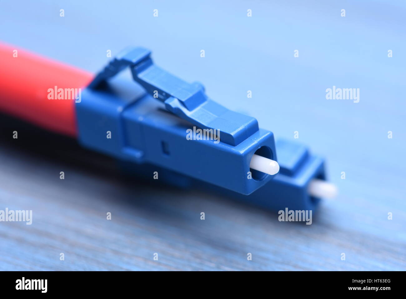 Close up of fiber optical cables single mode with LC type plug on blue ...