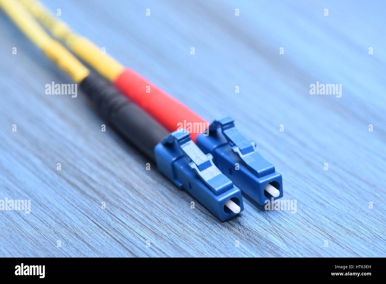 Close up of fiber optical cables single mode with LC type plug on blue ...