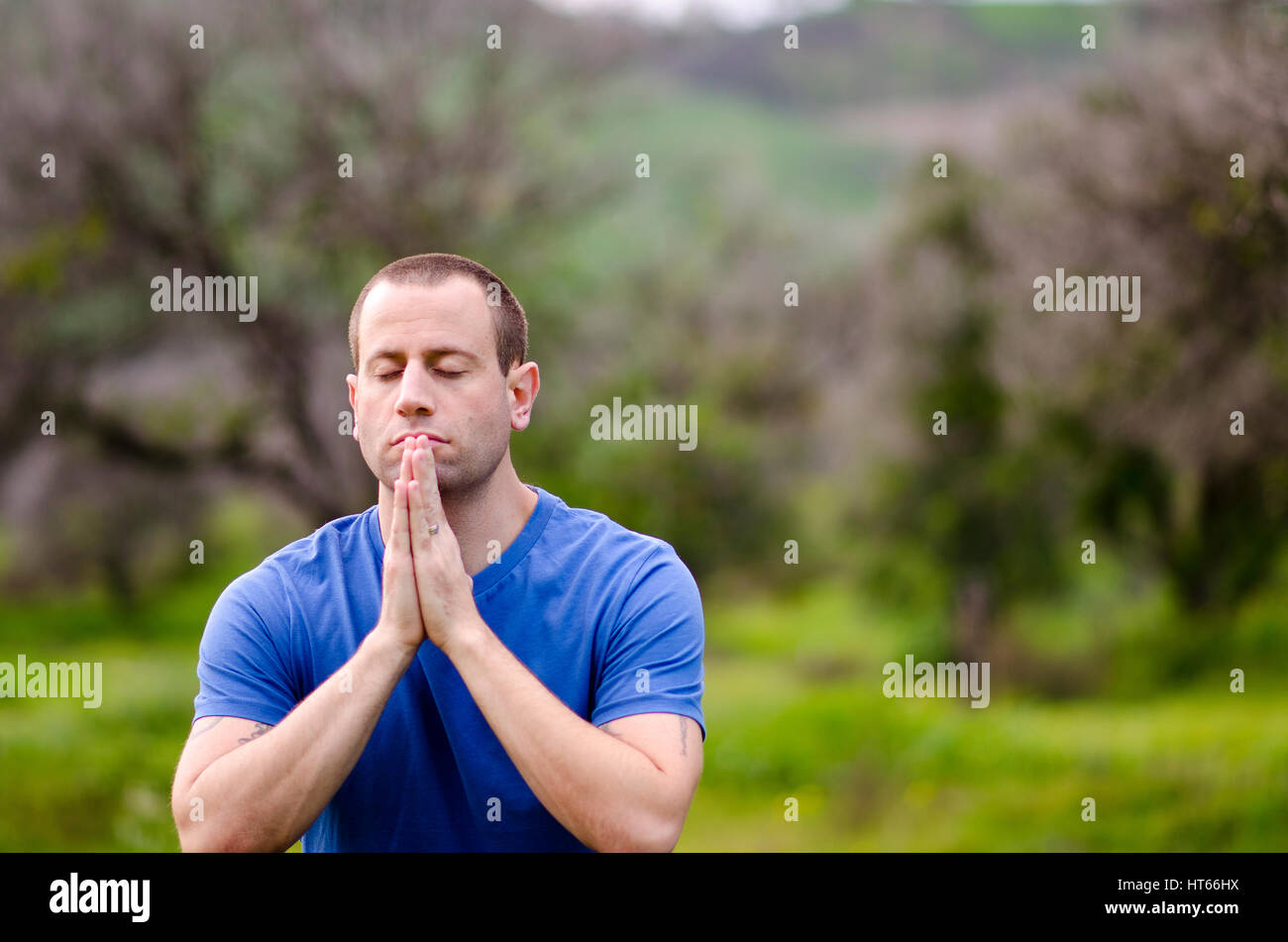 Man praying alone outside in nature Stock Photo - Alamy