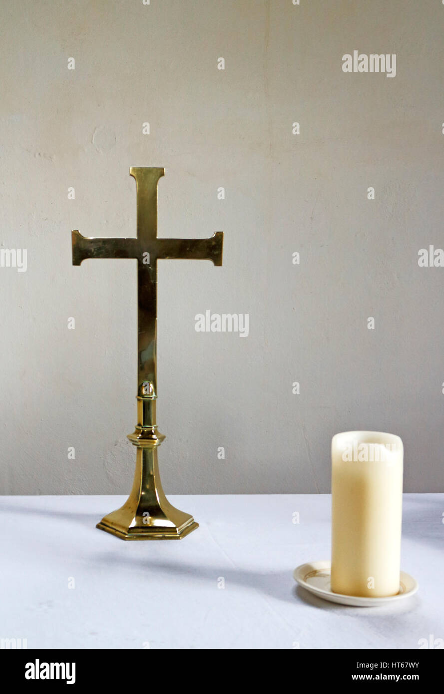 A still life of a cross and candle in a Norfolk country church at ...