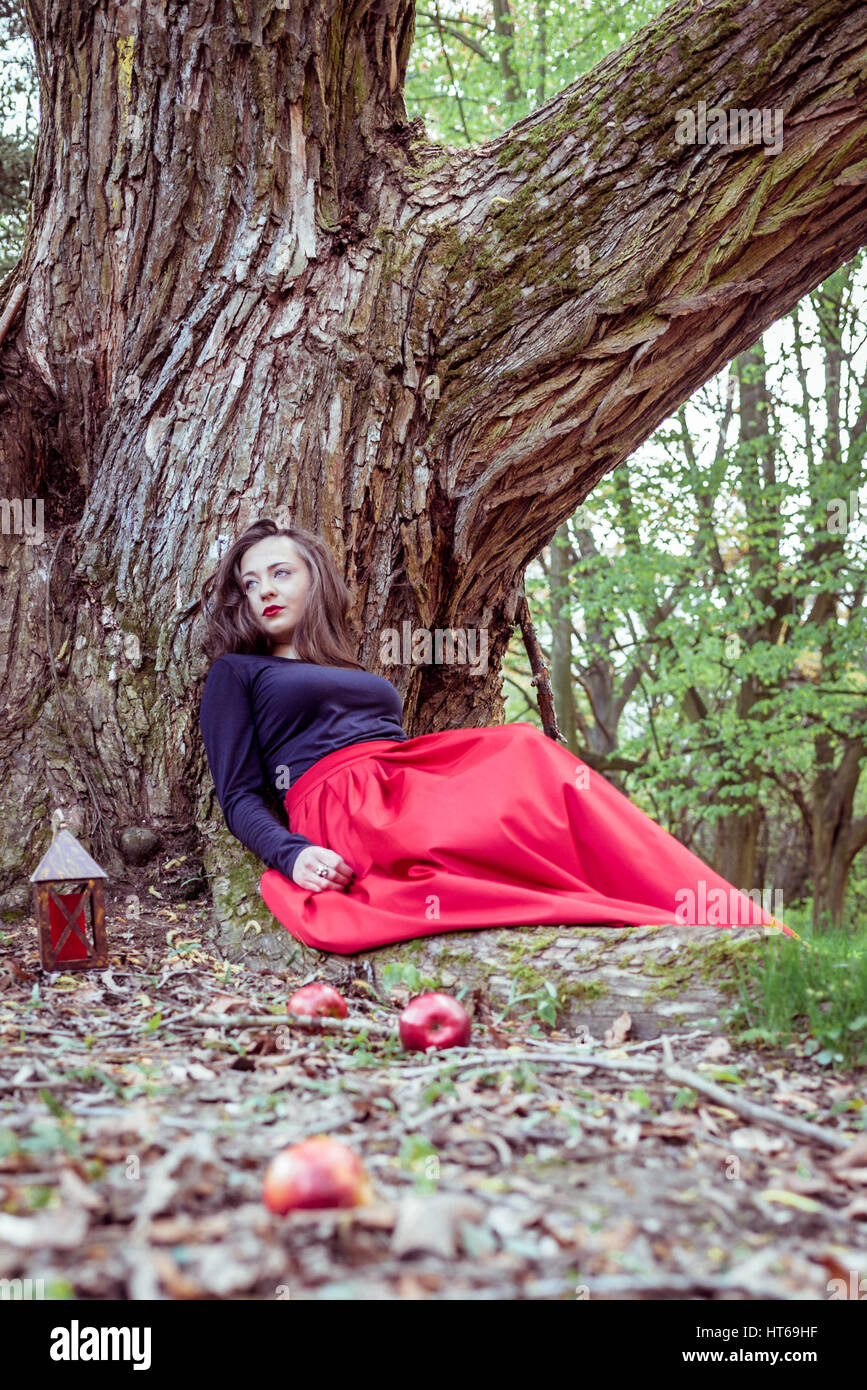 mystical witch woman sitting under a old tree in the forest Stock Photo ...