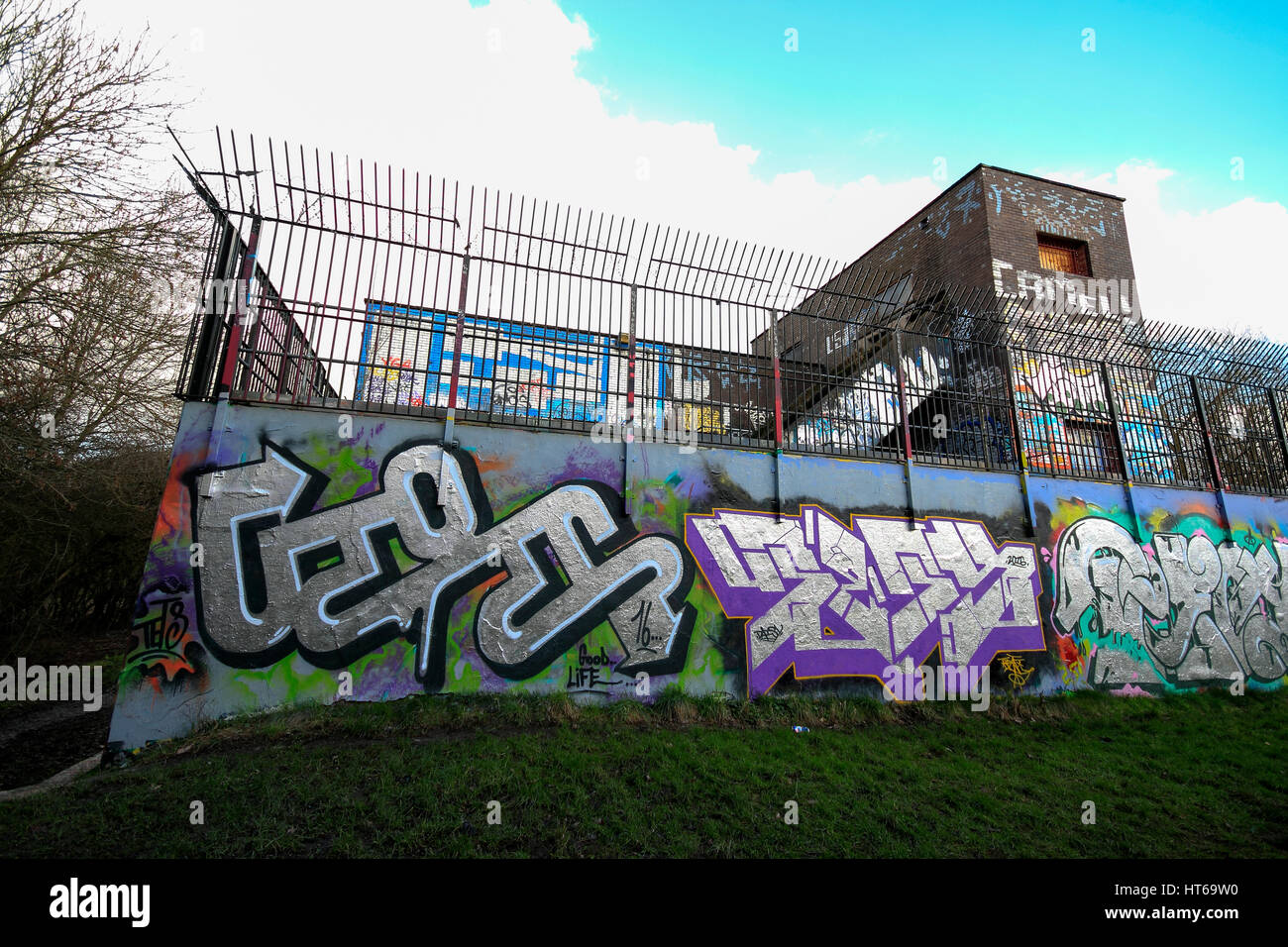 Colourful graffiti on a wall, sewage treatment building, Chorlton Ees ...