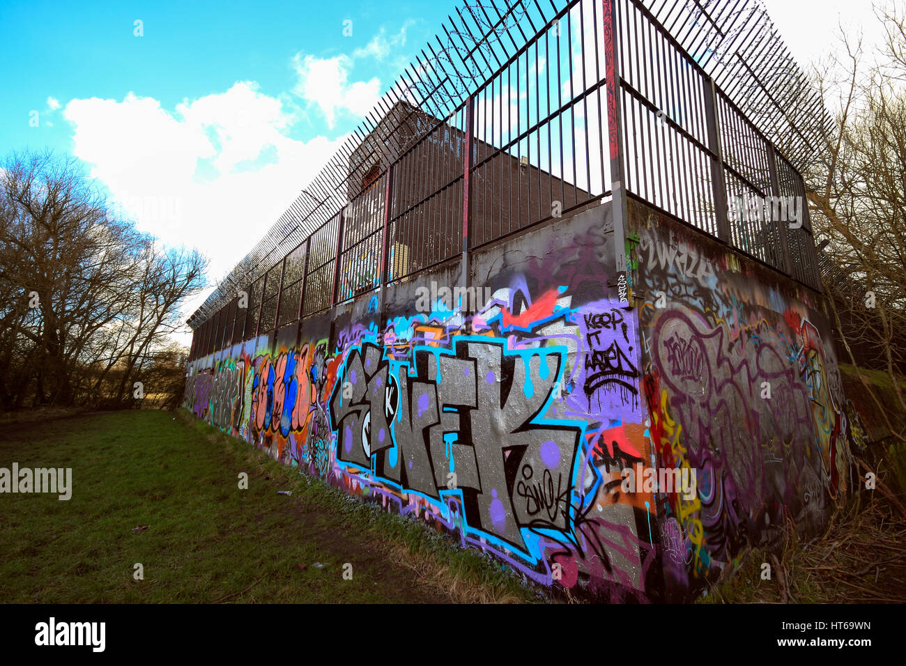 Colourful graffiti on a wall, sewage treatment building, Chorlton Ees ...