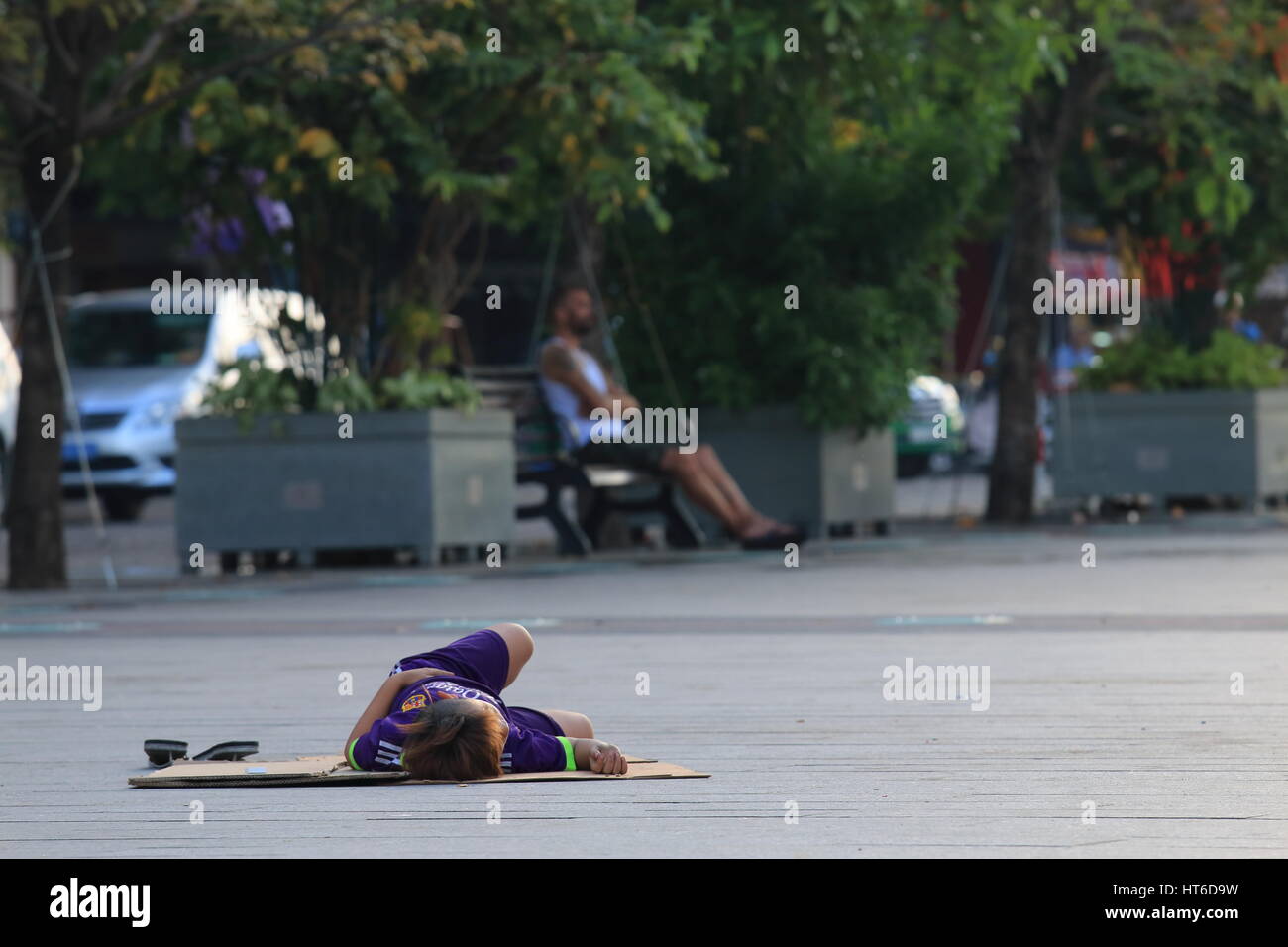 Homeless child sleeping on street hi-res stock photography and images ...