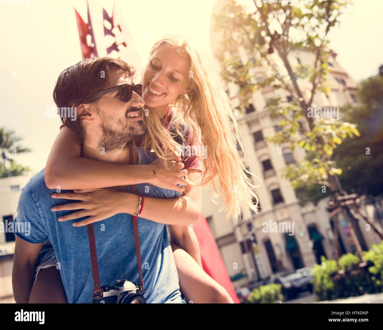 Sweet couple piggyback ride city Stock Photo - Alamy