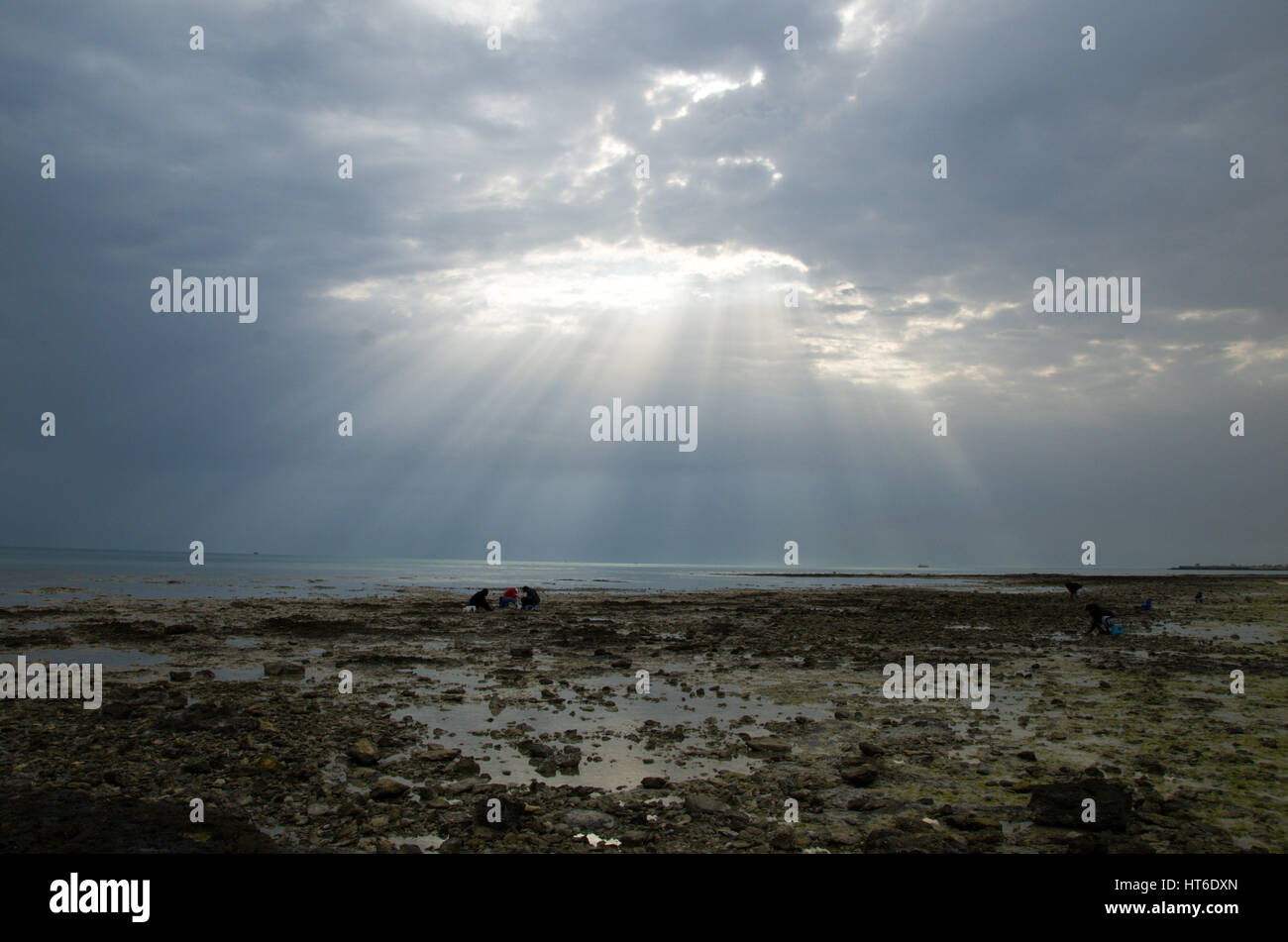 Beautiful view of sun rays penetrating through the clouds on the rocky ...