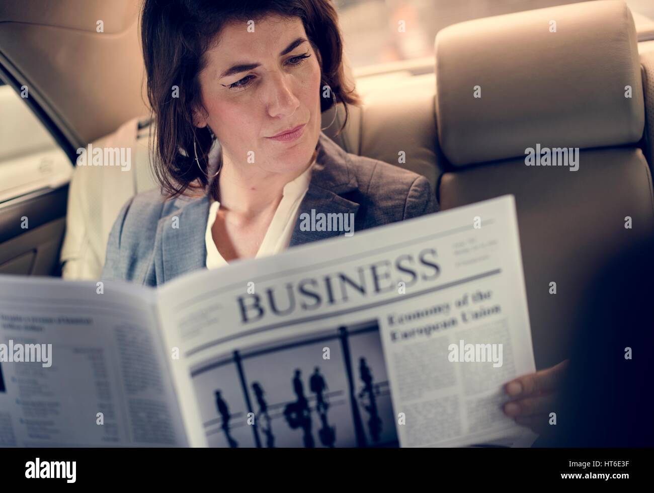 Businesswoman Reading Newspaper Car Inside Stock Photo - Alamy