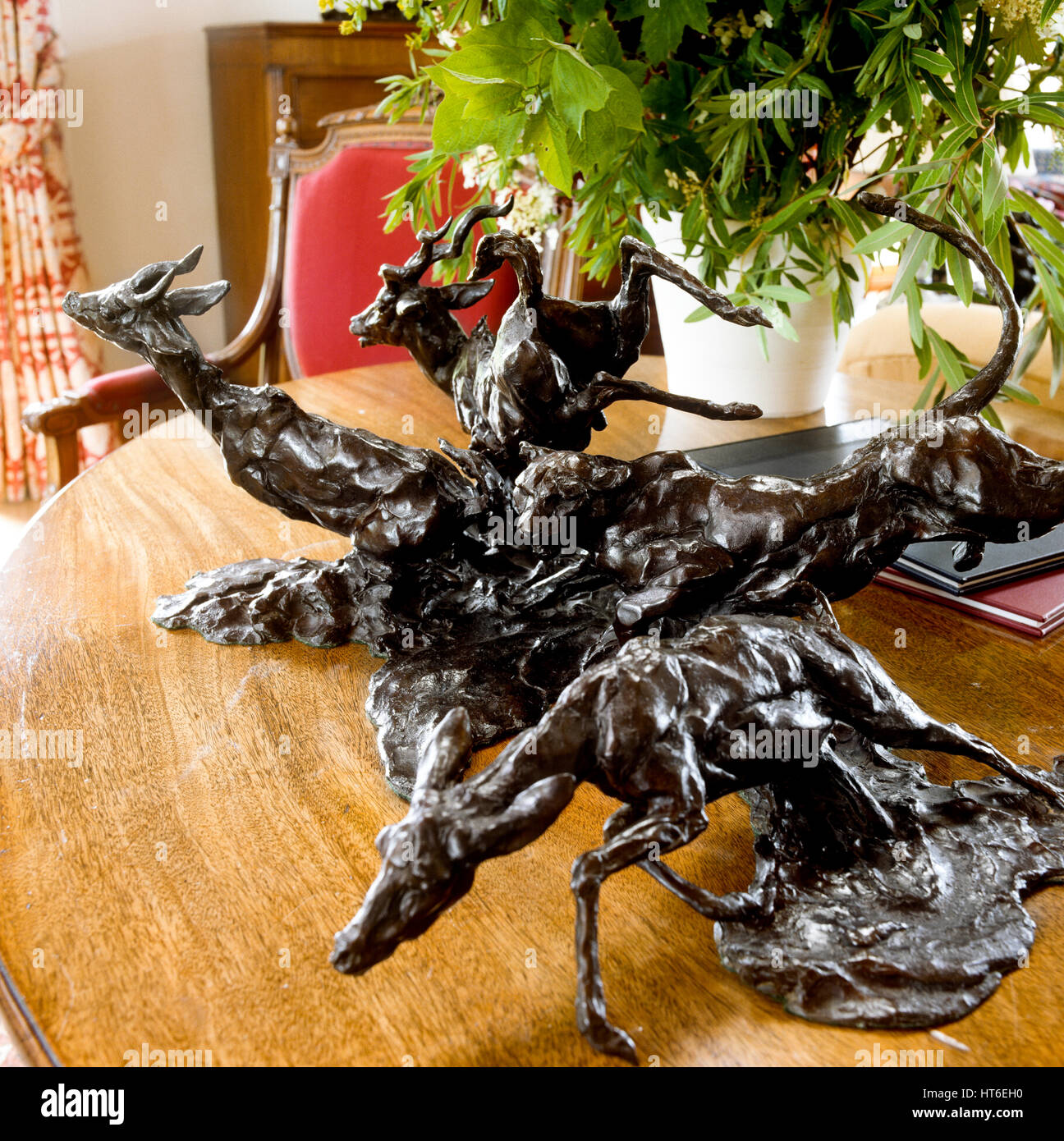 Sculpture of a lioness chasing antelope Stock Photo - Alamy