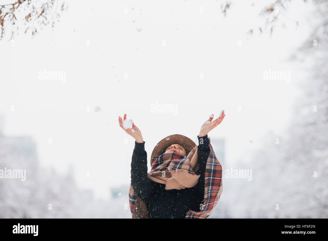 Woman catching snowflakes Stock Photo - Alamy