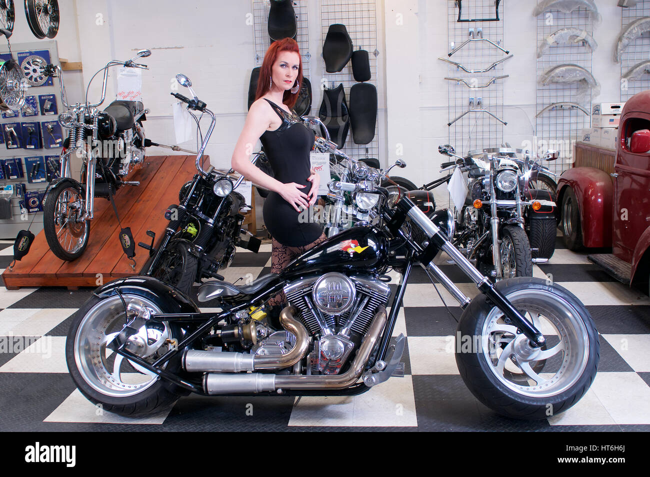Burlesque performer Sensu'Elle in a custom motorcycle shop wearing a ...