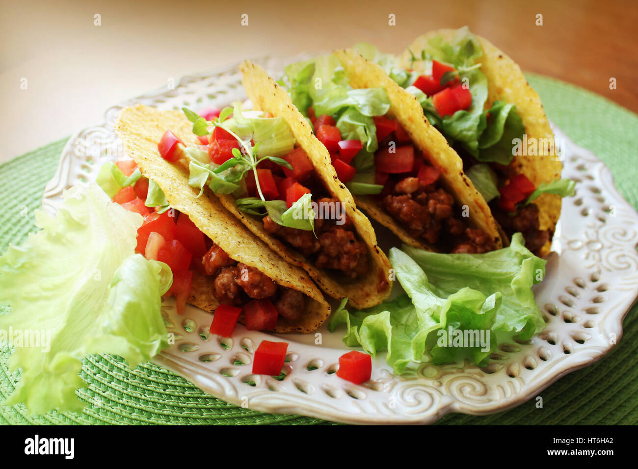 Mexican food - tacos with meat, lettuce and tomatoes Stock Photo - Alamy