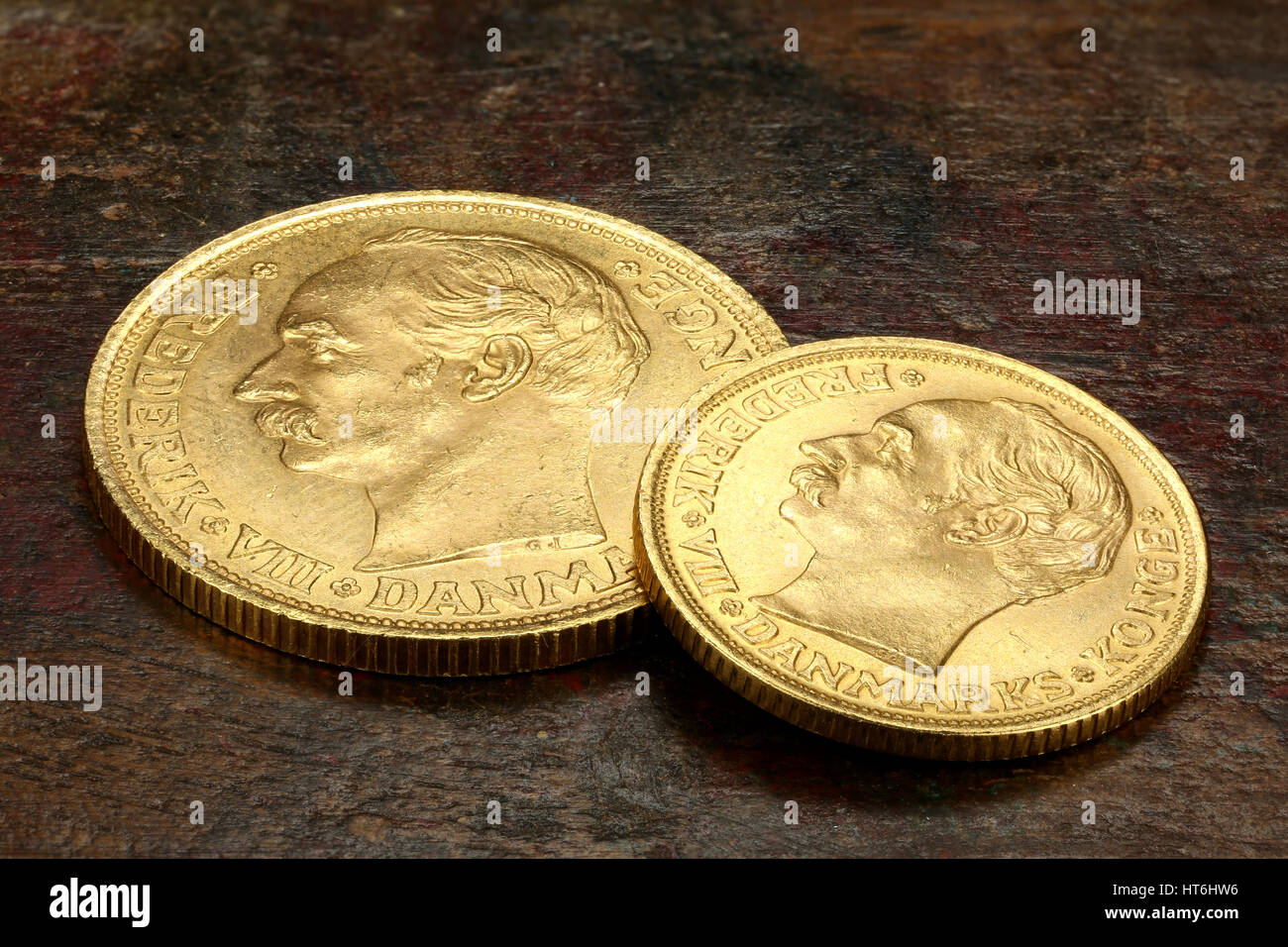 Danish gold coins on rustic wooden background Stock Photo - Alamy
