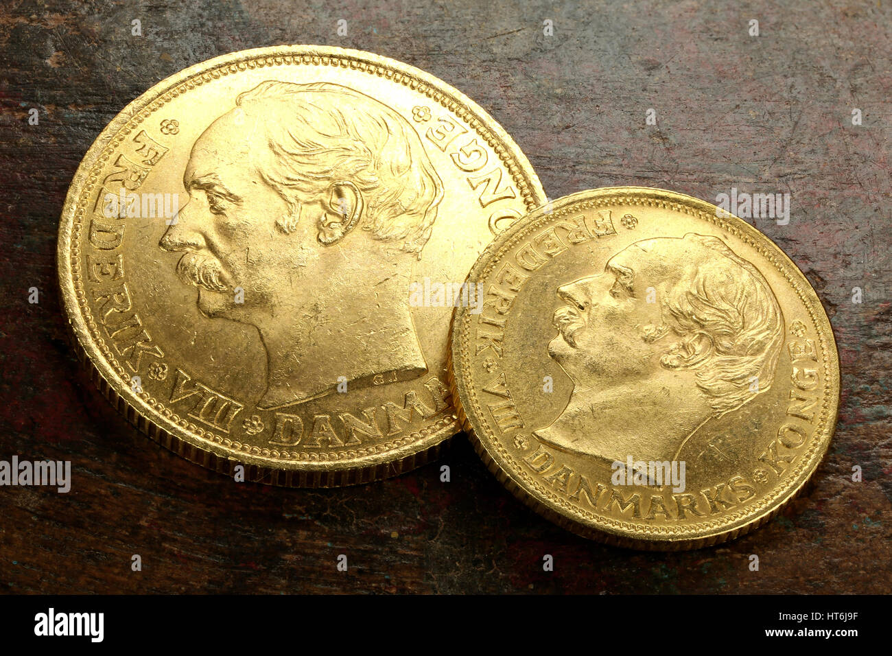 Danish gold coins on rustic wooden background Stock Photo - Alamy