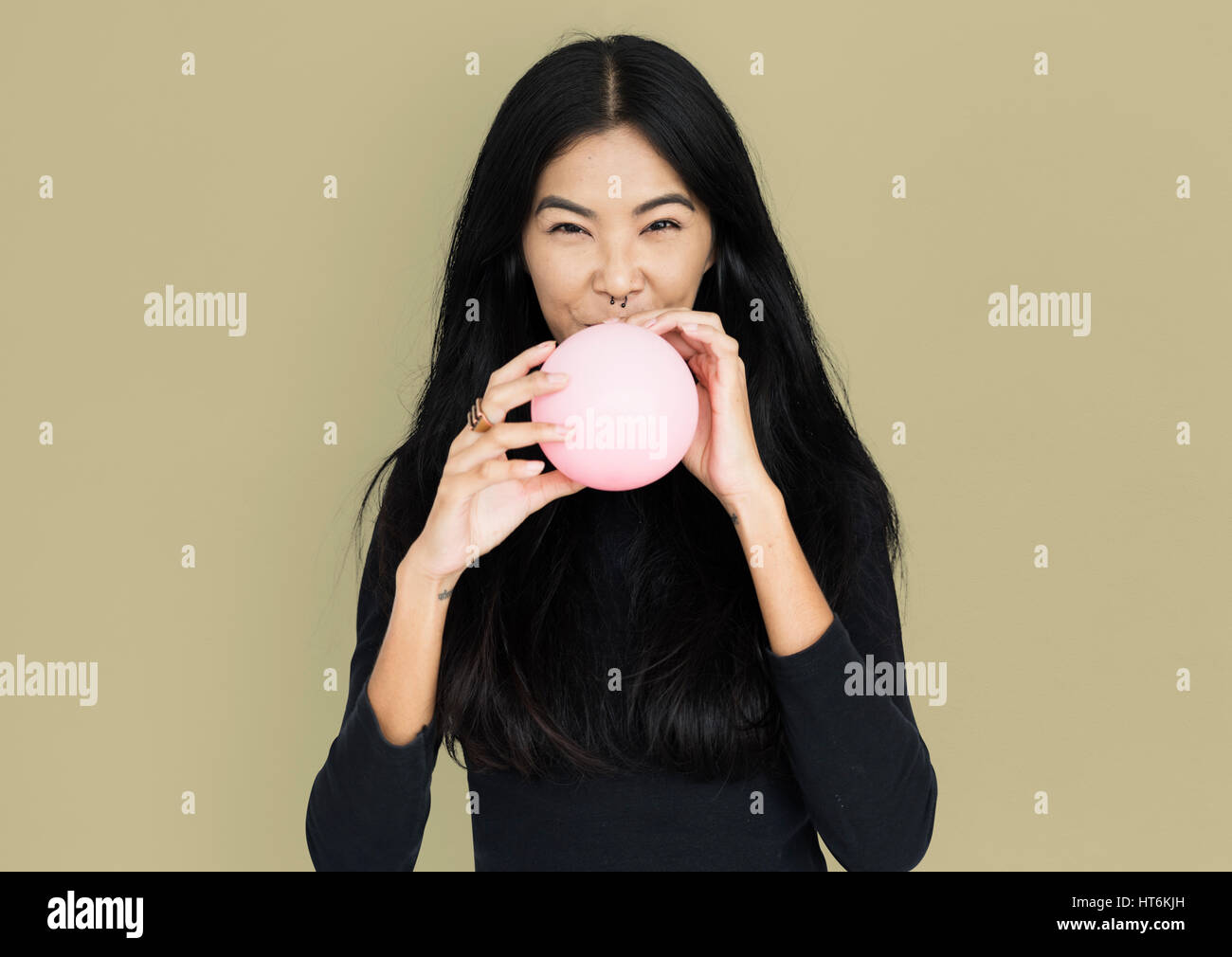 Young asian woman casual blowing a balloon Stock Photo - Alamy