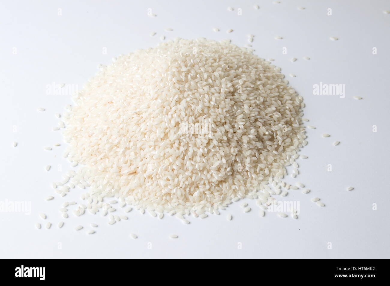 Pile of raw rice on white background Stock Photo - Alamy