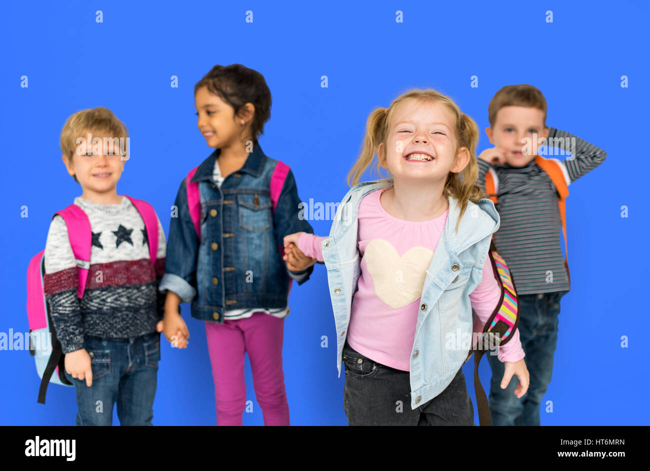 Little Kids Holding Hands Carrying Backpacks Stock Photo - Alamy